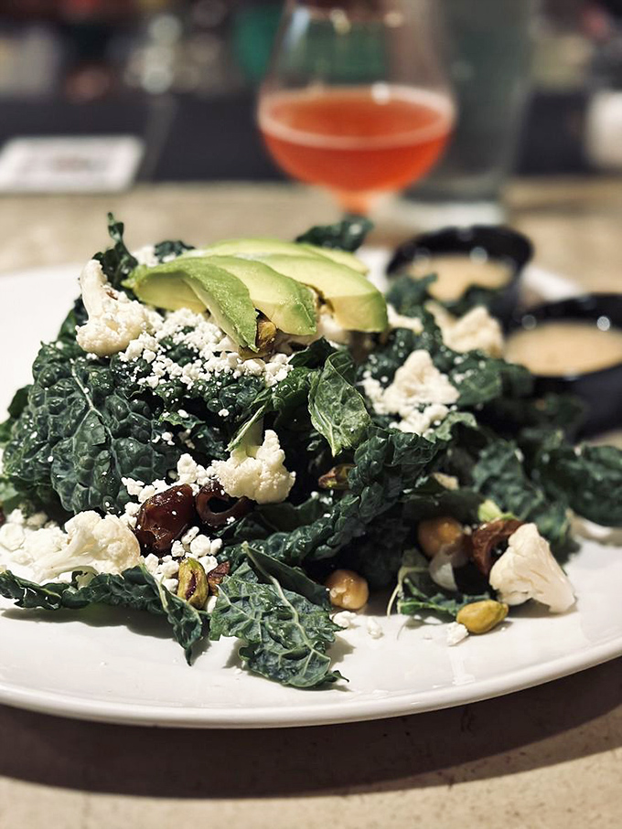 This kale salad is the Switzerland of the menu&mdash;neutral territory where health-conscious diners can feel virtuous while eyeing everyone else's burgers.