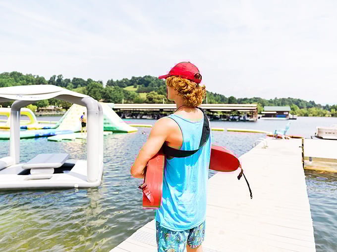 A lifeguard stands ready while visitors test their balance. The unspoken agreement: you provide spectacular wipeouts, they provide safety and discretion.