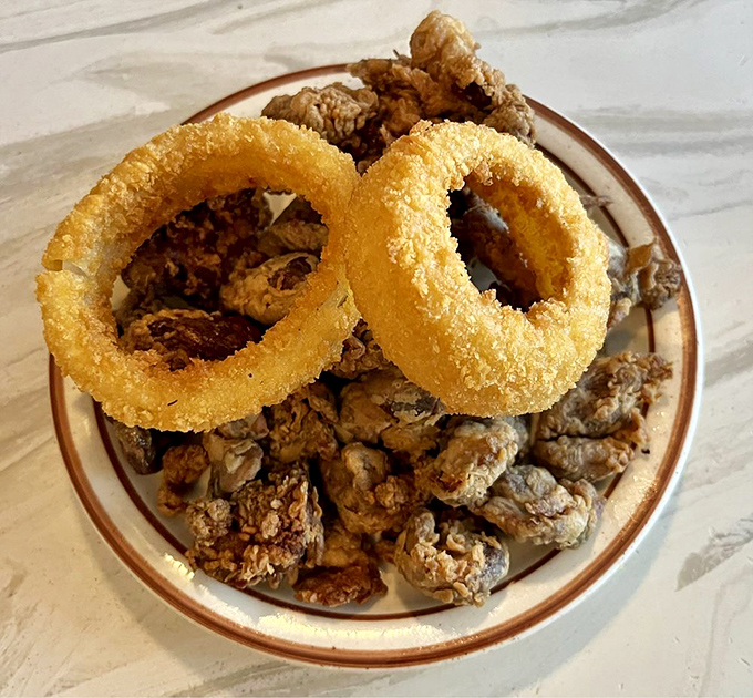 Crispy onion rings crowning a throne of gizzards and livers&mdash;a plate that separates the casual diners from the true fried chicken aficionados. 