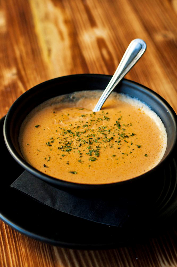 This lobster bisque isn't just soup&mdash;it's a velvety ocean hug in a bowl, garnished with herbs that whisper, "Yes, you deserve this."