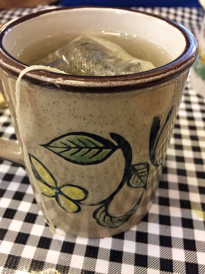 That's not just tea&mdash;it's a ceramic-cradled ritual, steeped in tradition and served on a checkered tablecloth that's seen more stories than a small-town librarian.