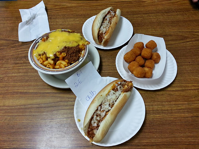 A complete Texas Hot Dogs feast: two dogs, onion rings, deviled eggs, and coleslaw. The kind of meal that makes diets weep with jealousy.