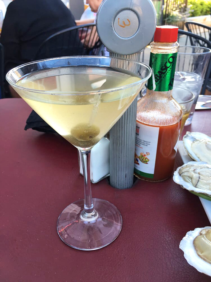 A classic martini sits elegantly beside fresh oysters—proof that some pairings are timeless for good reason.