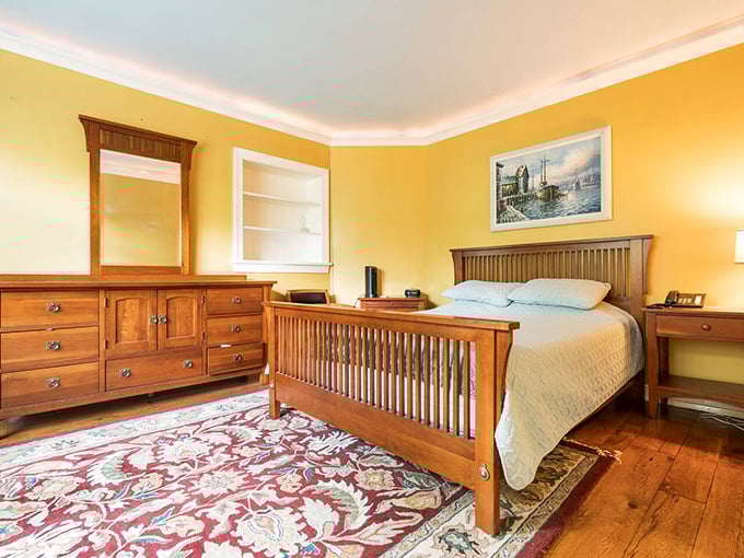 The master bedroom's sunny yellow walls and mission-style furniture offer a surprisingly cheerful contrast to the castle's imposing exterior.