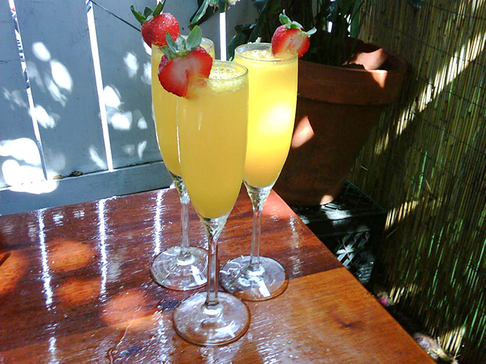 Sunshine in a glass! These mimosas topped with fresh strawberries aren't just drinks&mdash;they're permission slips to start your vacation day with a proper splash.