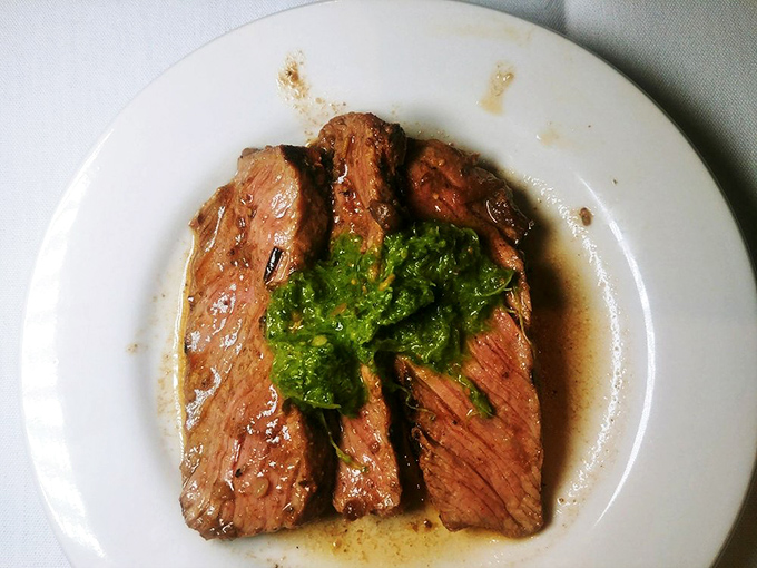 A steak adorned with herb butter melting into its perfectly seared surface, with green beans that actually taste like vegetables should. Revolutionary concept!