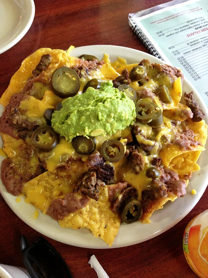 Nachos that laugh in the face of minimalism. Every chip supports a skyscraper of beans, cheese, jalape&ntilde;os, and guacamole&mdash;architecture you can eat.