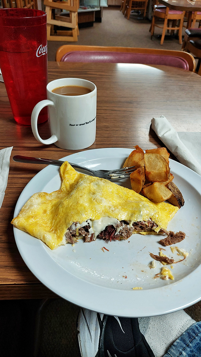 This omelet has more fillings than my last dental appointment, but tastes infinitely better. Coffee mug wisdom included at no extra charge.