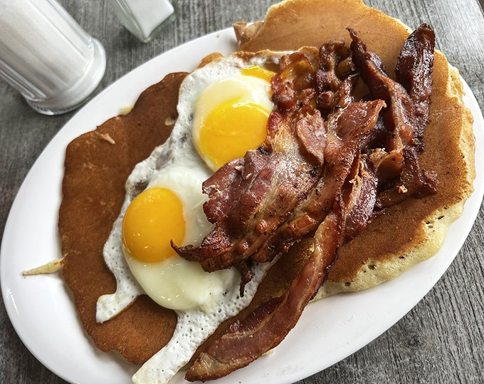 The holy trinity of breakfast: perfectly cooked eggs, crispy bacon, and a golden pancake&mdash;simpler than calculus but somehow more satisfying than solving world peace.