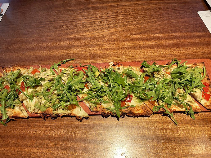 This flatbread isn't just a meal&mdash;it's an edible garden party where pesto, chicken, and fresh greens mingle on a perfectly crisp dance floor.