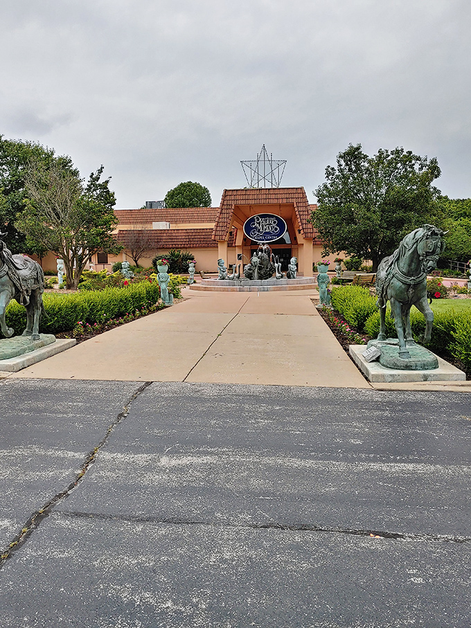 The Precious Moments Chapel entrance welcomes visitors with charming sculptures and meticulous landscaping. Whimsy and faith in perfect harmony.