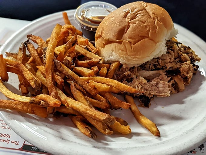 This pulled pork sandwich with hand-cut fries isn't just lunch – it's edible evidence that simplicity, done right, beats fancy every time.