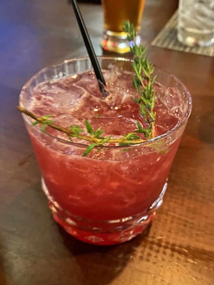 The raspberry smash cocktail&mdash;where fruit and booze find their higher purpose. That sprig of rosemary isn't garnish; it's aromatherapy.