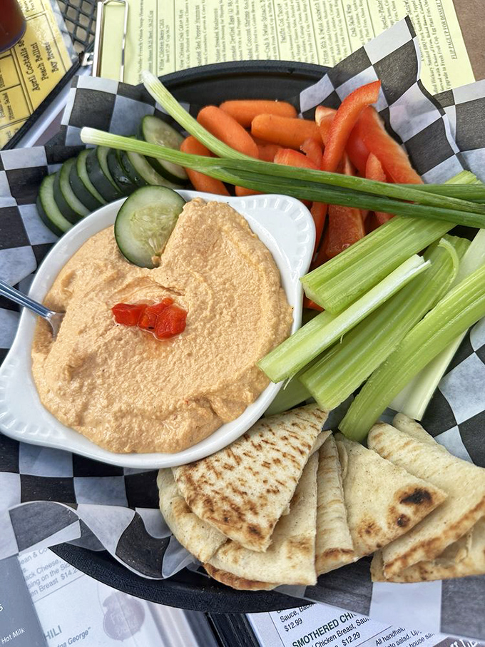 Hummus that doesn't apologize for being healthy. Fresh vegetables and warm pita create the perfect delivery system for this creamy, garlicky spread.