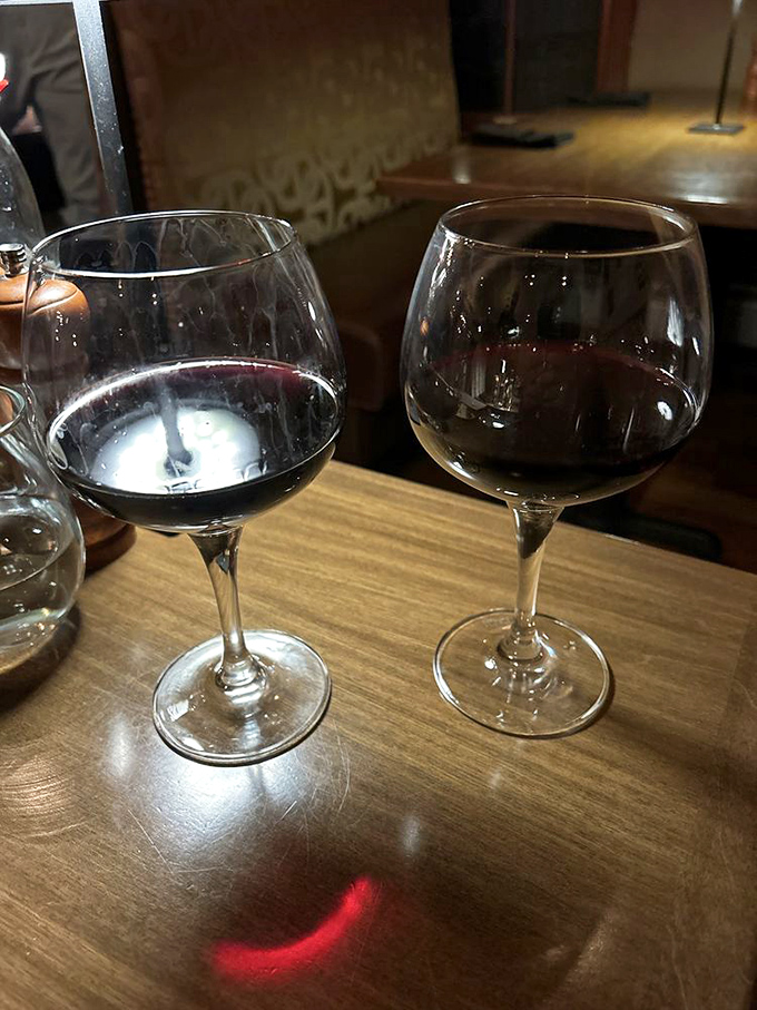 Two glasses of robust red wine catching the light just so&mdash;because great steak deserves an equally distinguished drinking companion. The start of many good decisions. 