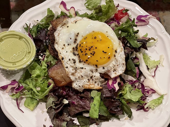 Who knew a salad could make you forget you came for a burger? That sunny-side egg is like a sunrise over a garden of deliciousness.