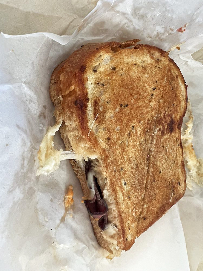 This toasted Reuben has that perfect cheese pull that food photographers dream about. The sandwich equivalent of a California sunset&mdash;dramatic and worth the wait.