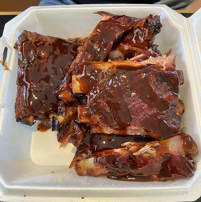 These ribs have clearly been slow-dancing with smoke for hours. The sauce is just the final love letter to your taste buds.