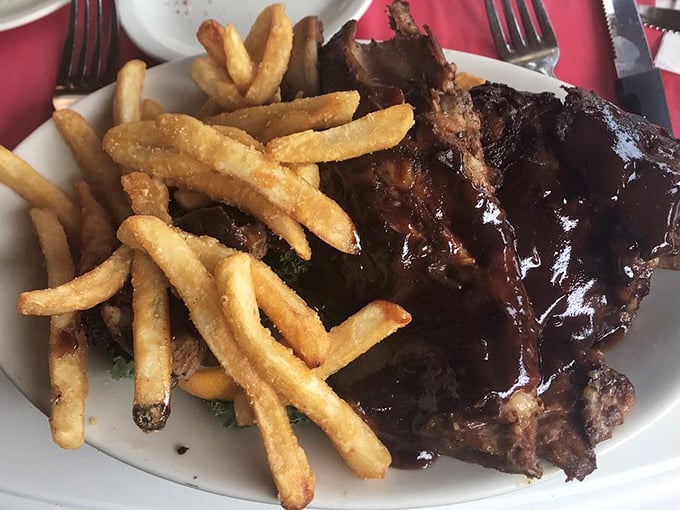 Ribs glazed with a sauce so shiny you could check your reflection in it, paired with fries that demand to be savored.