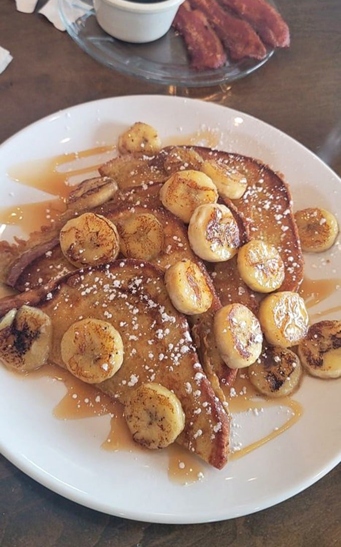 French toast that makes you question every other breakfast decision you've ever made – caramelized bananas performing a sweet ballet.
