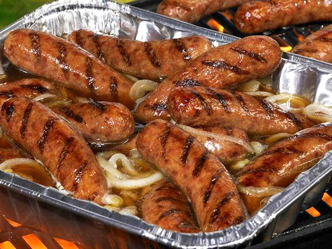 Sausages bathing in their own juices, grill marks telling stories of flame-kissed perfection&mdash;a Wisconsin love letter in meat form.