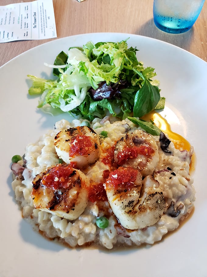 Perfectly seared scallops perched atop creamy risotto&mdash;the culinary equivalent of a standing ovation, with each bite delivering a crescendo of flavors.