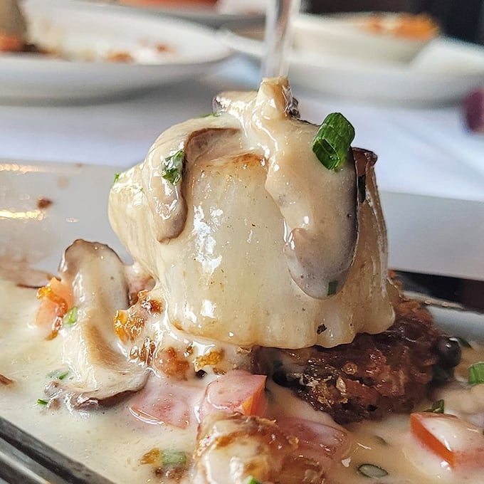 This isn't just seafood; it's a love letter to the ocean, delivered with creamy sauce and nestled on what appears to be a bed of pure contentment.