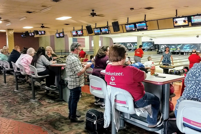 Where generations gather around laminate tables, sharing stories between frames and celebrating the simple joy of knocking things down.