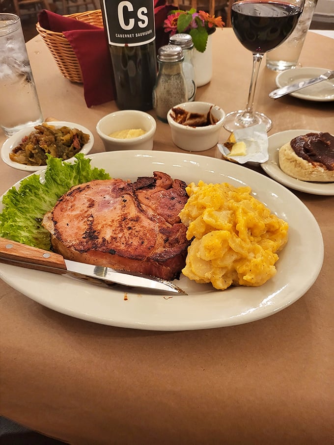 A perfectly seared pork chop shares the plate with mac and cheese that glows like Missouri sunshine &ndash; this is what happiness looks like on a plate.