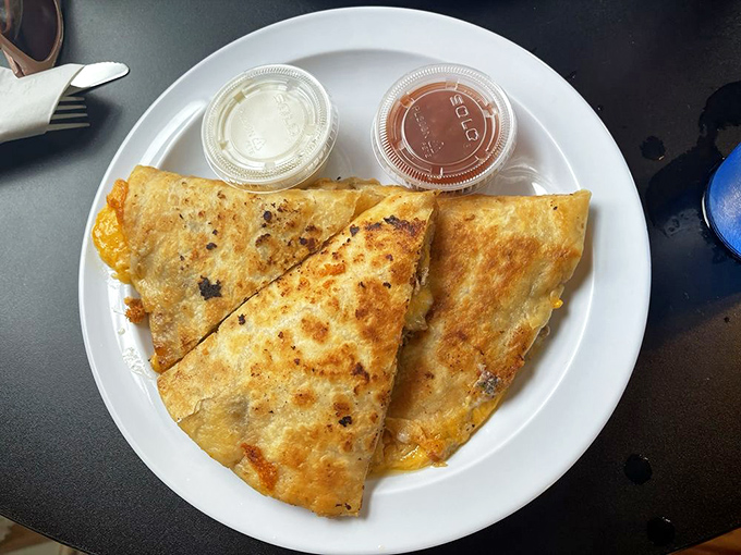 Quesadillas that achieve that perfect balance—crispy exterior, gooey cheese interior, and two dipping sauces because life's too short to choose just one.