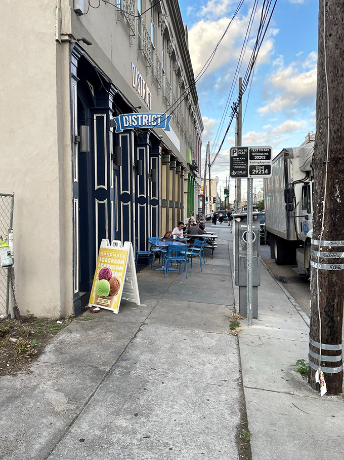 The Lower Garden District sidewalk view&mdash;where New Orleans architecture meets deli culture in a beautiful collision of worlds worth exploring.