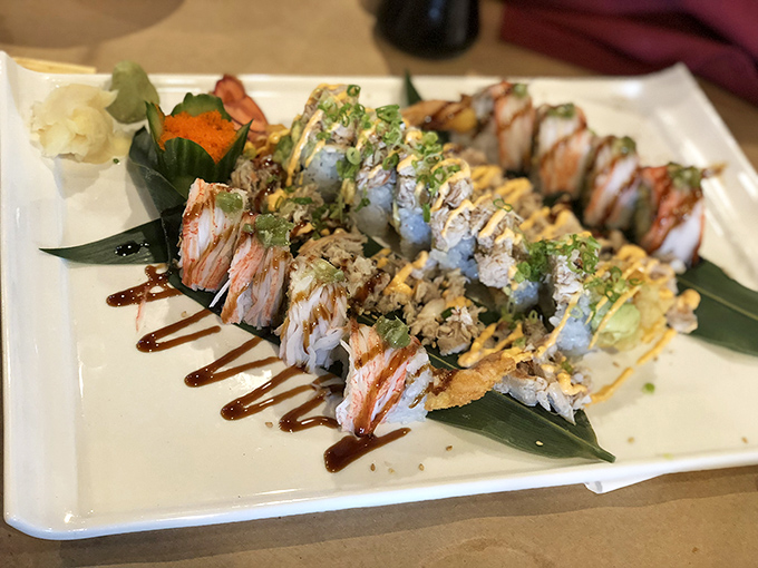 Sushi rolls presented with such artistry that you almost feel guilty dismantling them. Almost. That drizzle of sauce is calling your name.