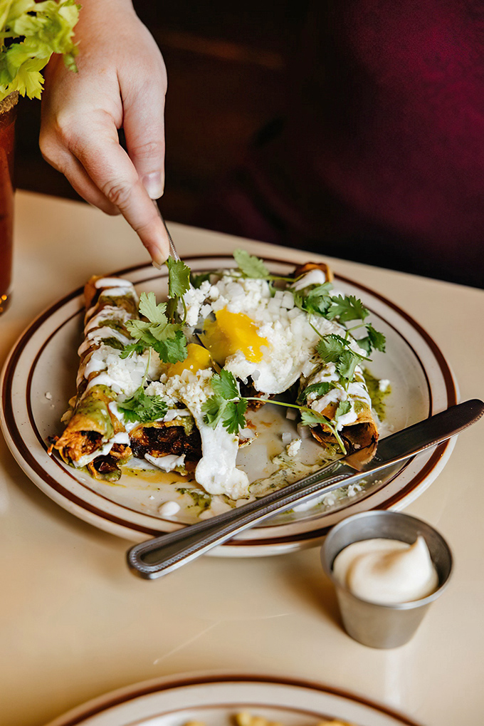 These aren't just any taquitos—they're breakfast's exciting plot twist, topped with a sunny-side-up egg that's ready for its Instagram moment.