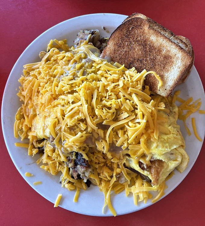 The Scrambler: where eggs, potatoes, and cheese unite in a breakfast alliance so powerful it could solve world peace before noon.