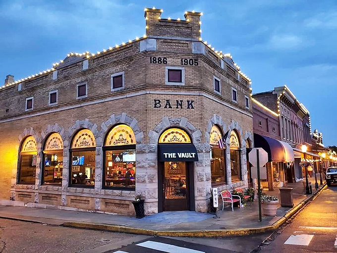 The Vault 1905 Sports Grill brilliantly repurposes a historic bank. Those arched windows once watched over deposits; now they frame happy hour revelry.
