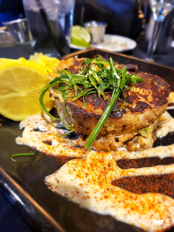 This isn't just a crab cake&mdash;it's a crab masterpiece, seared to golden perfection and drizzled with a sauce that deserves its own fan club.