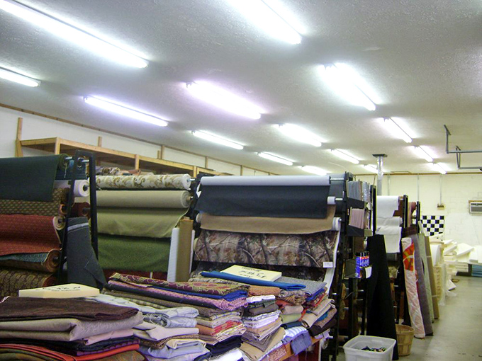 Upholstery fabrics stand at attention like textile soldiers, ready to transform that yard sale chair from "what were they thinking" to "where did you get that?"