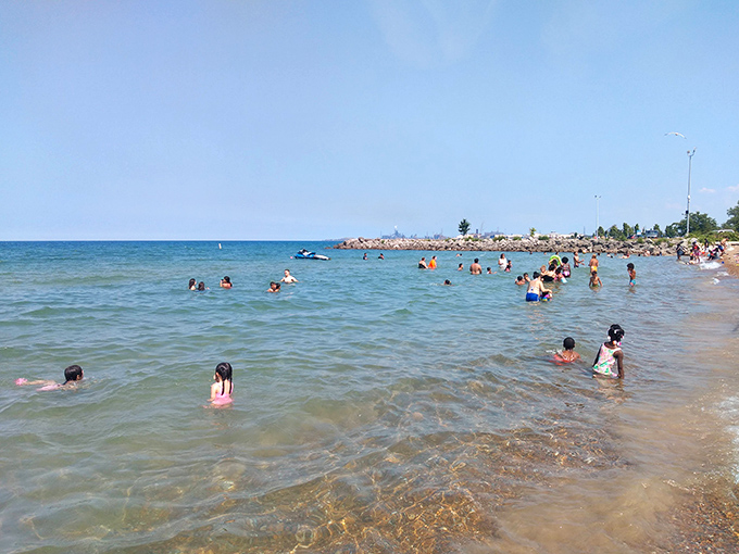 Aquatic adventurers wade toward inflatable glory. The yellow life jackets aren't just safety equipment&mdash;they're admission tickets to the bounciest party on the lake.