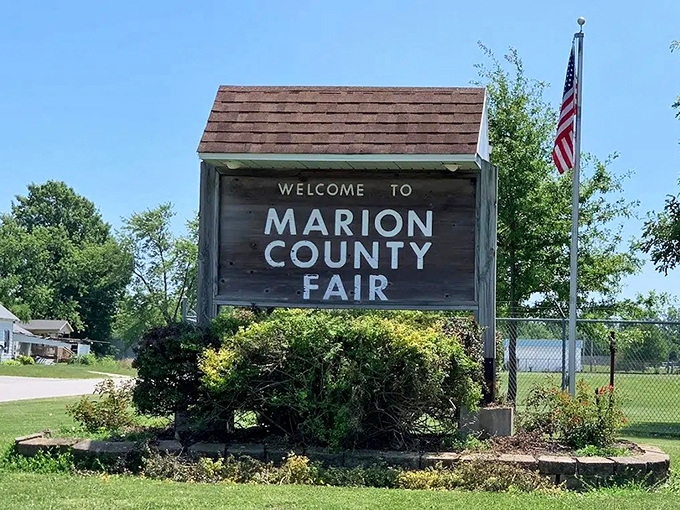 The Marion County Fair sign promises the timeless trifecta of summer joy: funnel cakes, livestock competitions, and rides that make you question your life choices.