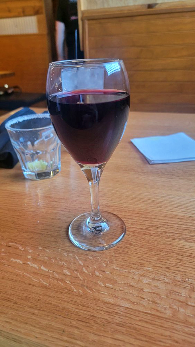 A glass of red wine waiting patiently to complement your steak&mdash;because sometimes adulting has its privileges.