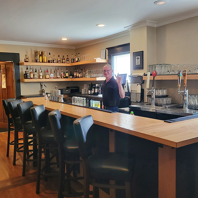 The bar&mdash;where cocktail magic happens and friendly faces await. Notice the well-organized bottles? That's the sign of people who know what they're doing.