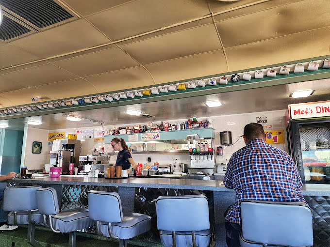 The counter at Mel's &ndash; where solo diners find community, regulars exchange neighborhood news, and the short-order ballet unfolds before your appreciative eyes.