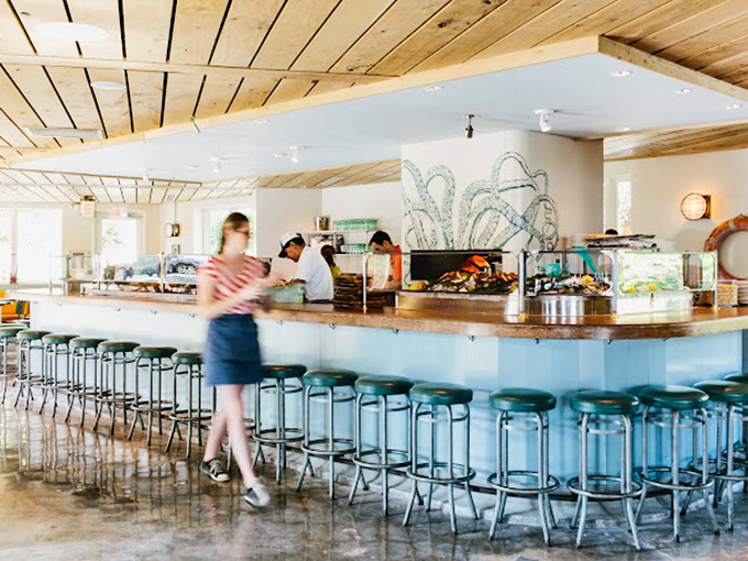 Industrial-chic meets maritime charm in a dining room where every table feels like the captain's table on a very stylish ship. 