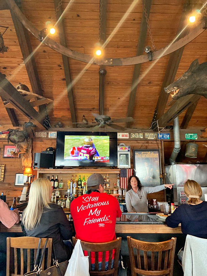 The bar where locals and tourists find common ground over cold drinks and football, beneath wooden beams that have heard every fish tale.