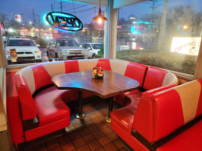 That corner booth by the window? Prime real estate for watching the world go by while keeping your coffee cup in the refill zone.