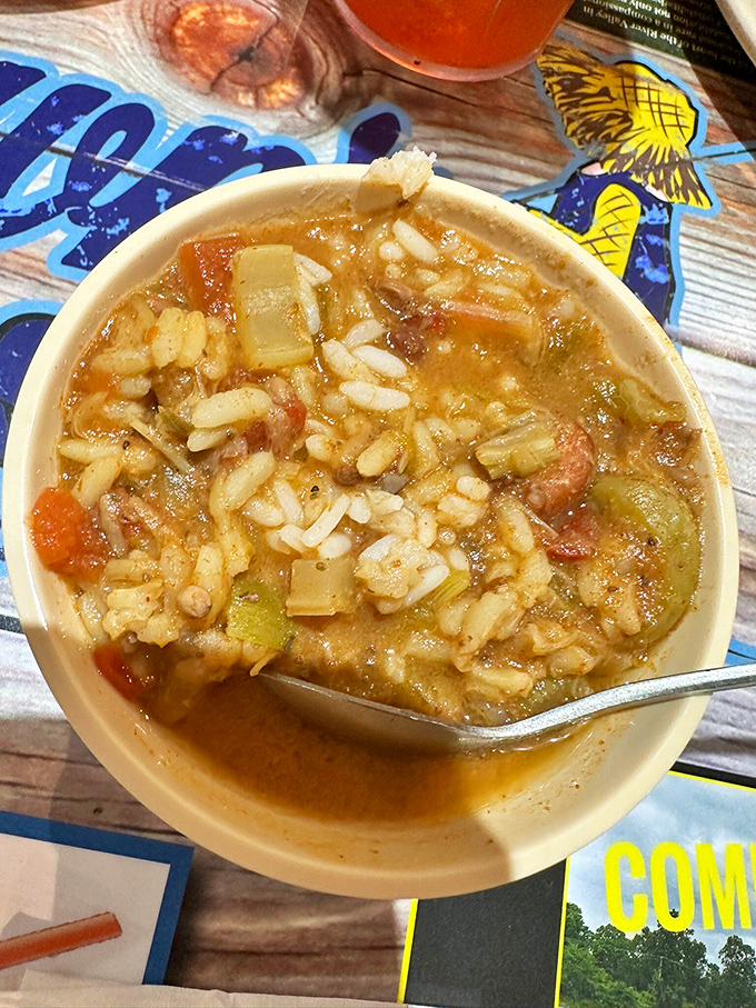 A steaming bowl of gumbo that whispers tales of slow-cooking and generations of Southern know-how with every aromatic spoonful.