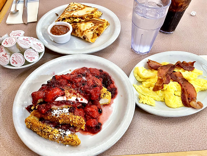 The breakfast trinity: perfectly scrambled eggs, crispy bacon, and a quesadilla that didn't know it was invited to the morning party.