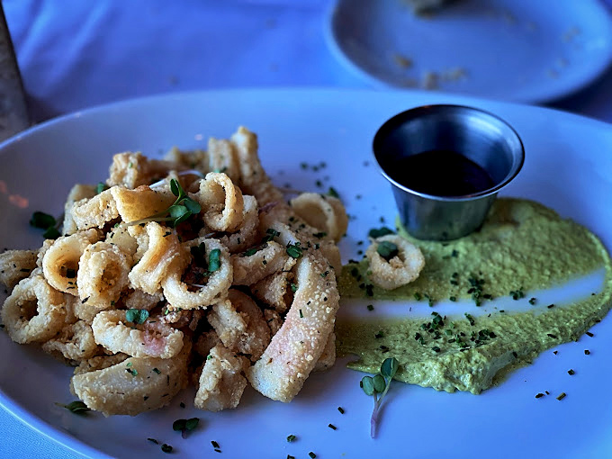Crispy calamari that shatters with each bite, paired with a vibrant green sauce that adds just the right amount of zing. 