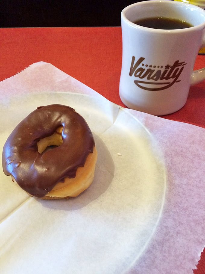The chocolate glazed with Varsity's branded mug&mdash;the classic pairing that's launched a thousand Monday mornings and saved countless work meetings.