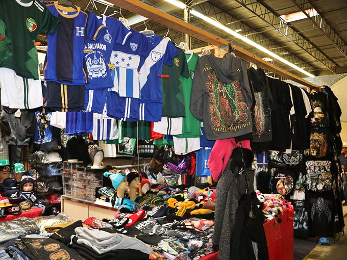 International soccer jerseys hang like colorful flags, a United Nations of sports fandom above mountains of bargain-priced footwear.